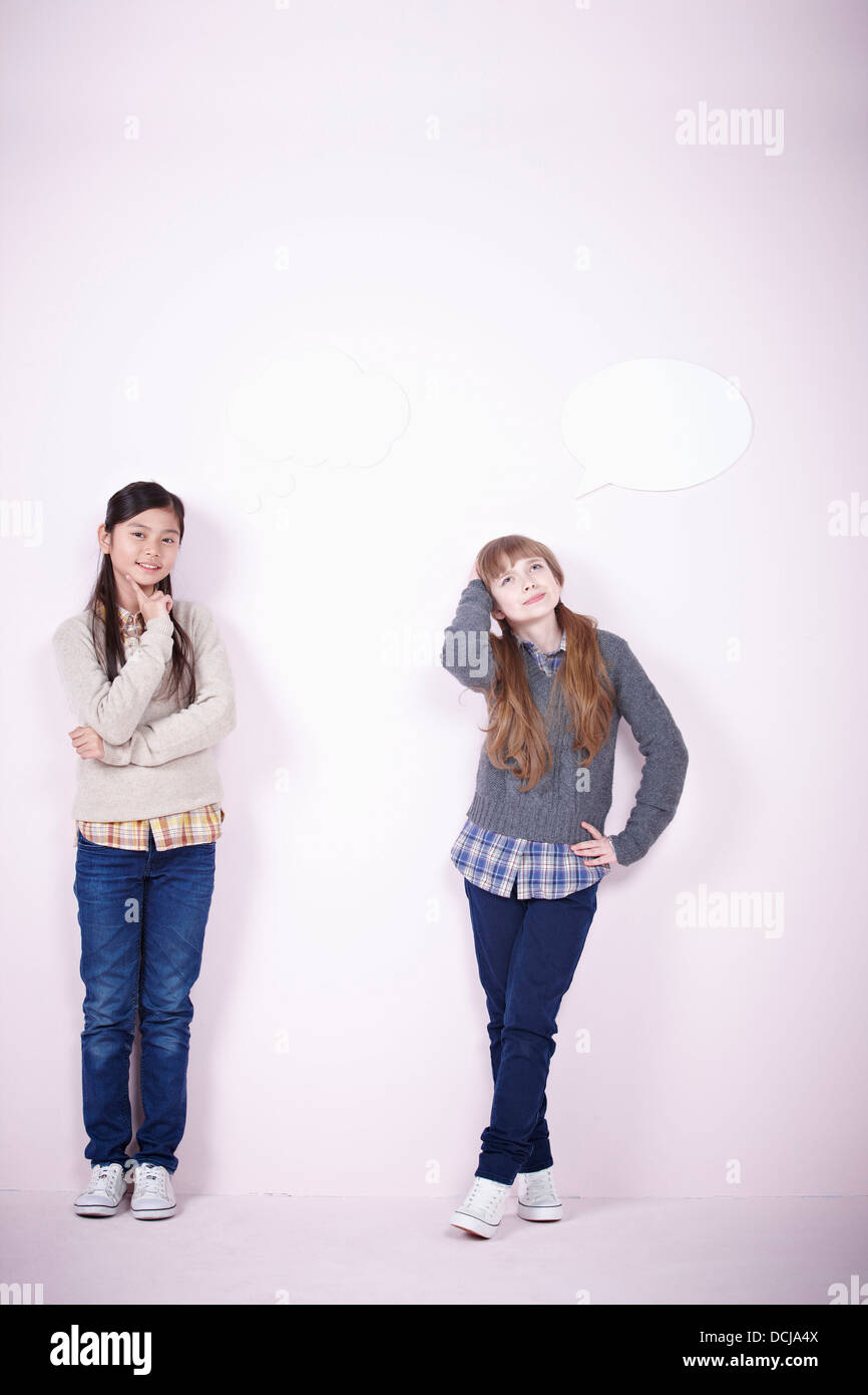 two girls standing together Stock Photo - Alamy