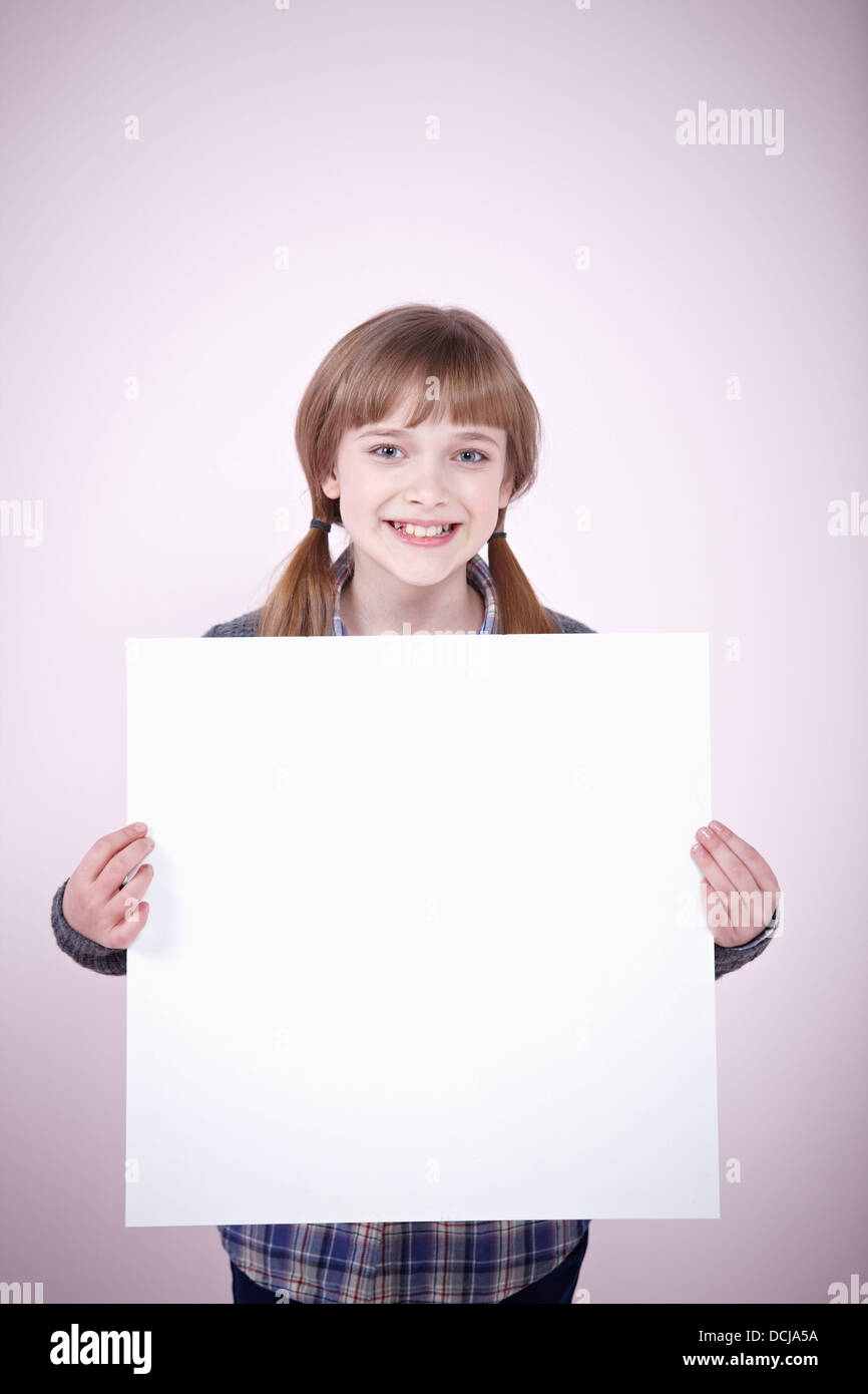 a girl holding a blank piece of paper Stock Photo - Alamy