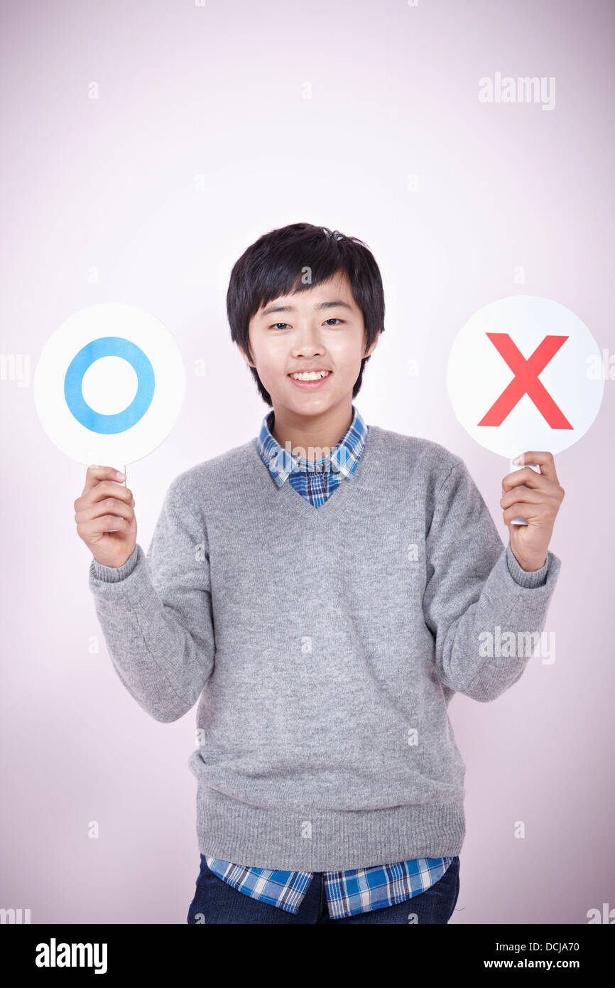 a boy holding boards saying correct and wrong Stock Photo - Alamy