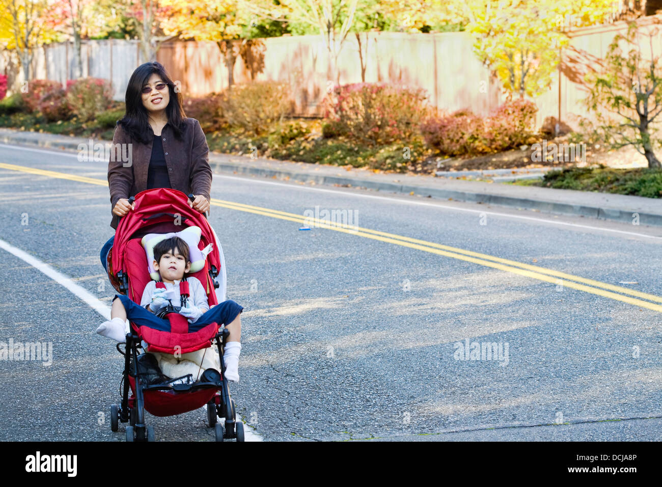 Mother pushing her son in the stroller Stock Photo - Alamy