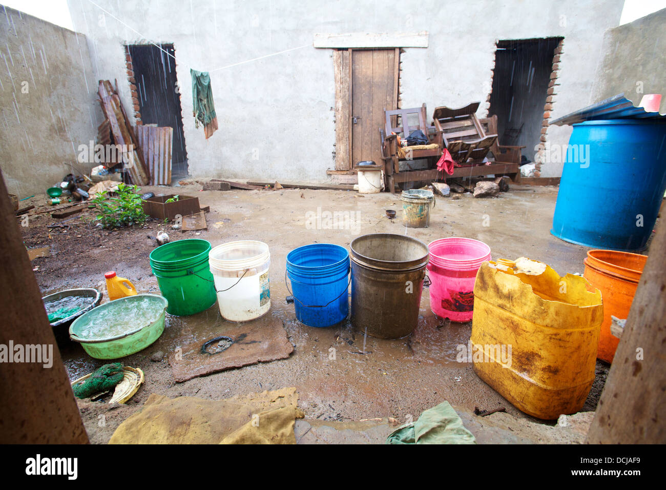 Buckets laid out in a courtyard to collect rainwater, Tanzania, Africa ...