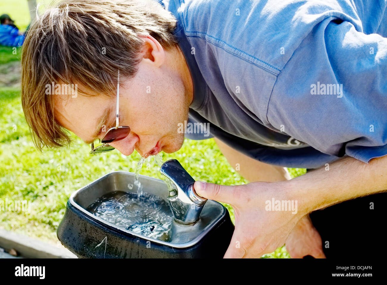 Man drinking water from fountain Stock Photo - Alamy