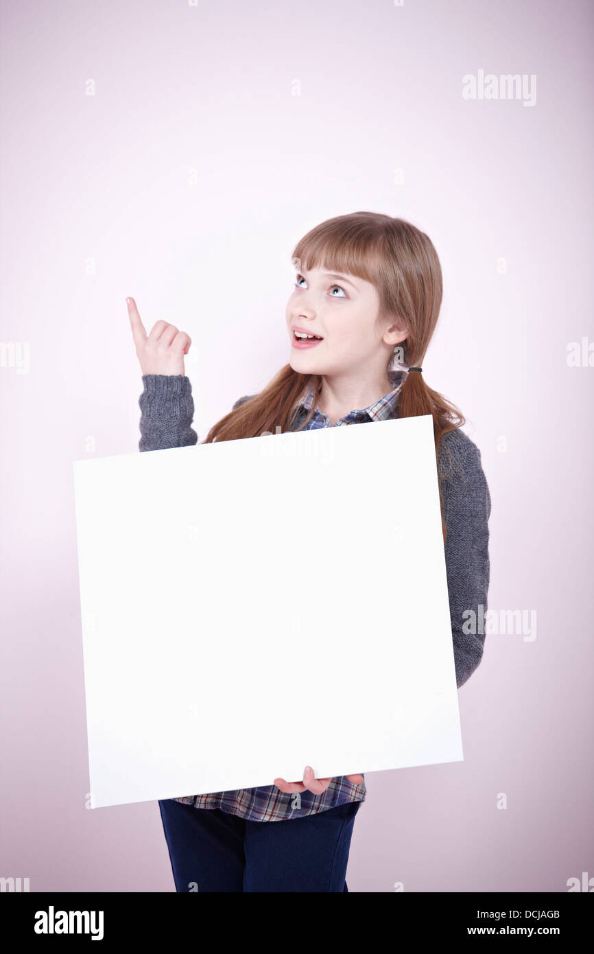 a girl holding a blank piece of paper Stock Photo - Alamy