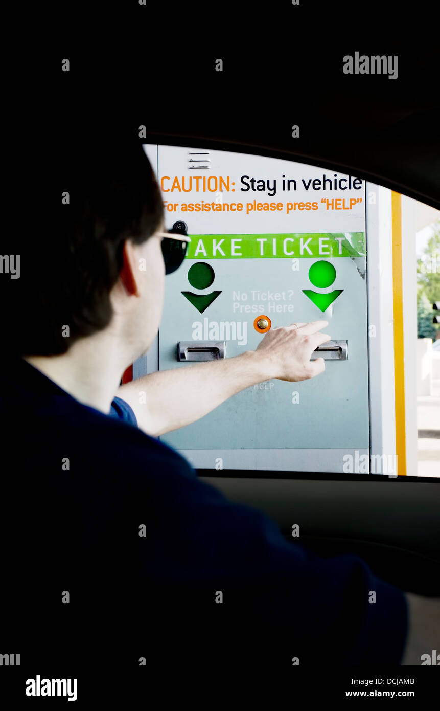 Man taking ticket from toll booth Stock Photo - Alamy