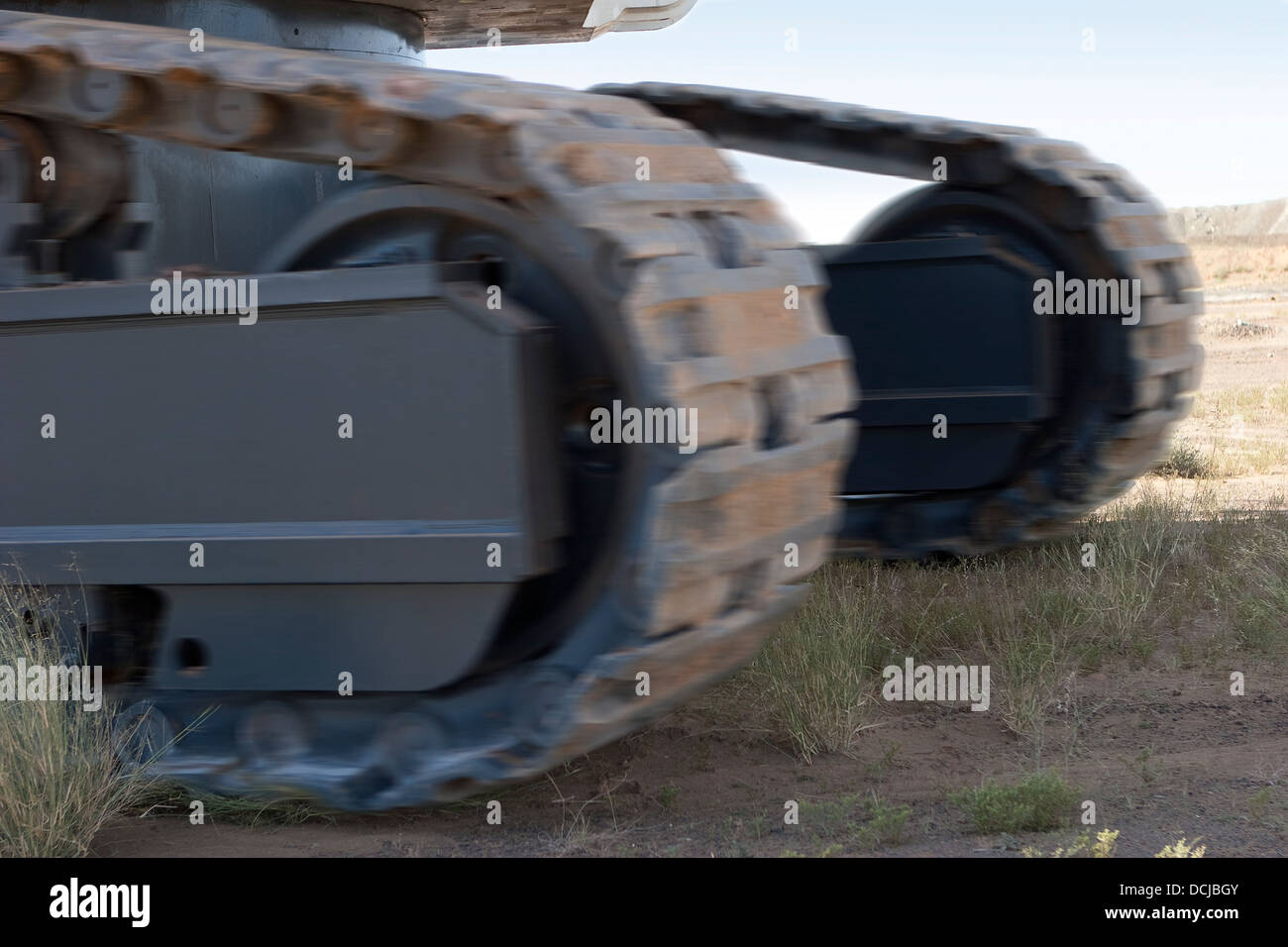 Close up of tracks of giant hydraulic excavator digger moving to new ...