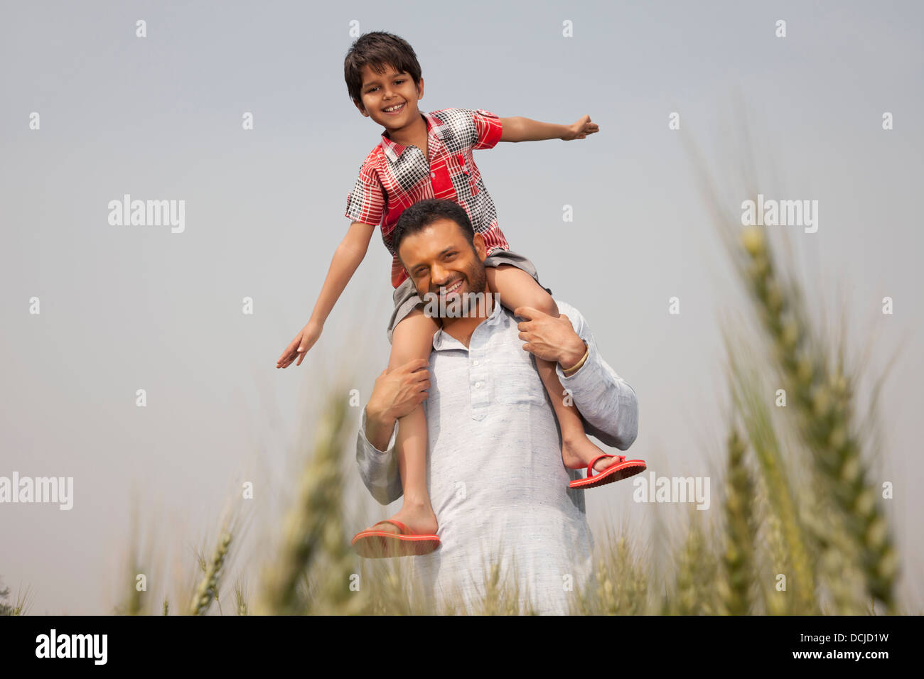 Portrait of a man carrying little boy on shoulders Stock Photo - Alamy