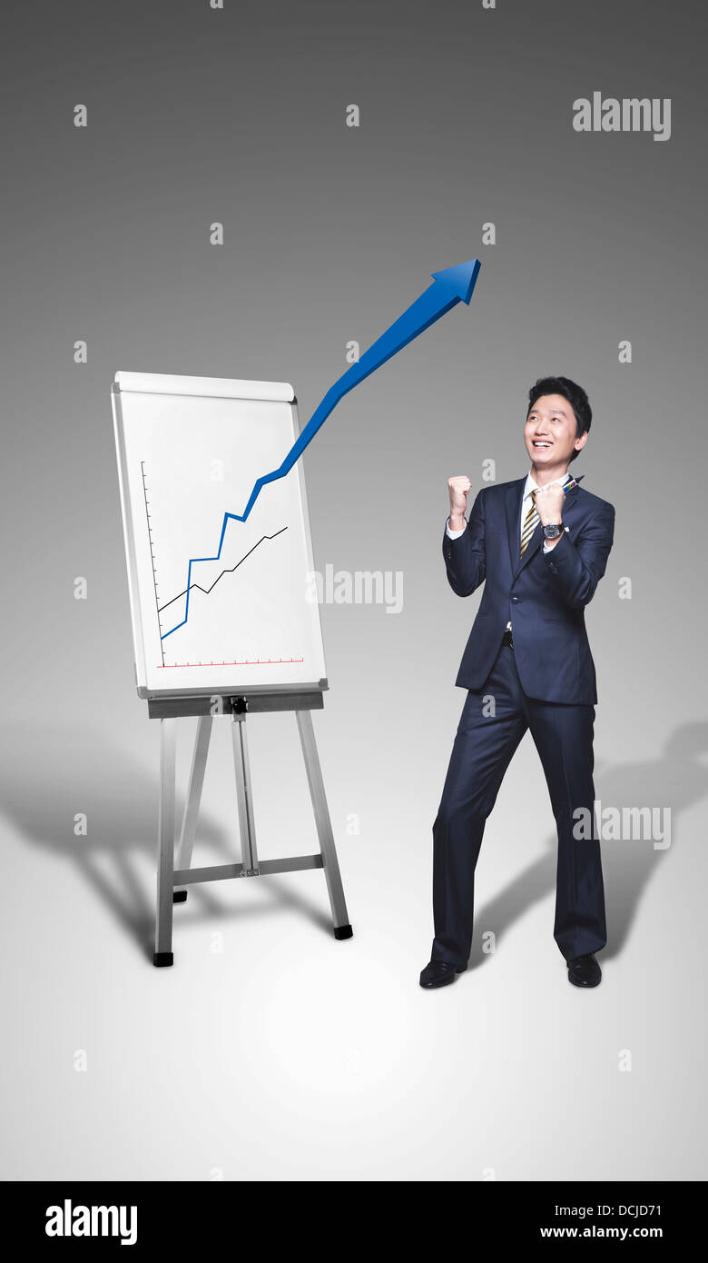 a businessman with a graph rising Stock Photo - Alamy