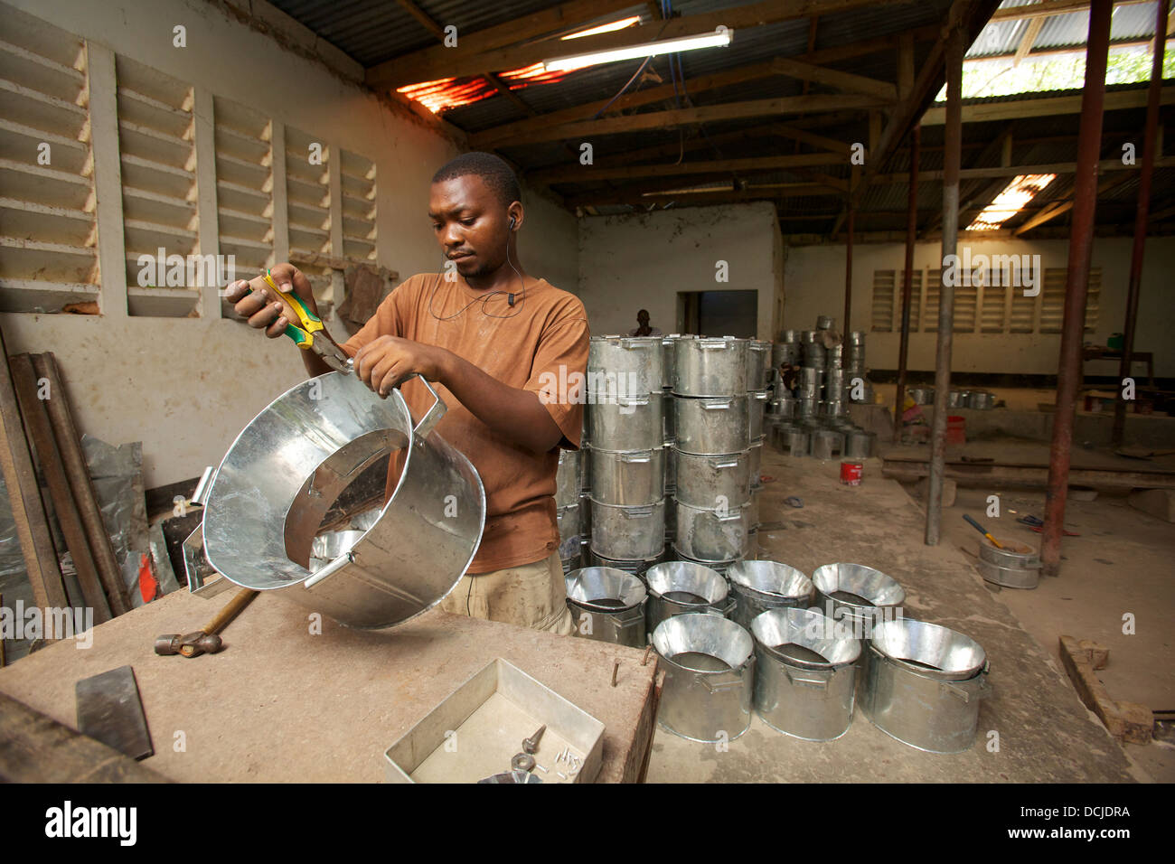 Metal craftsman constructing an african cooking stove, Tanzania Stock ...