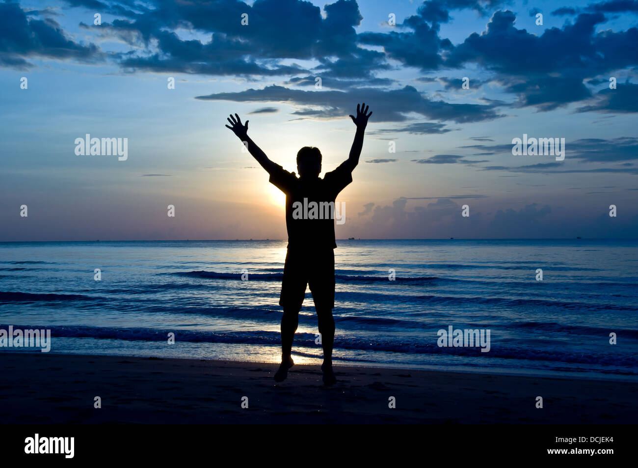 silhouette of feel free and happy man on the beach Stock Photo - Alamy