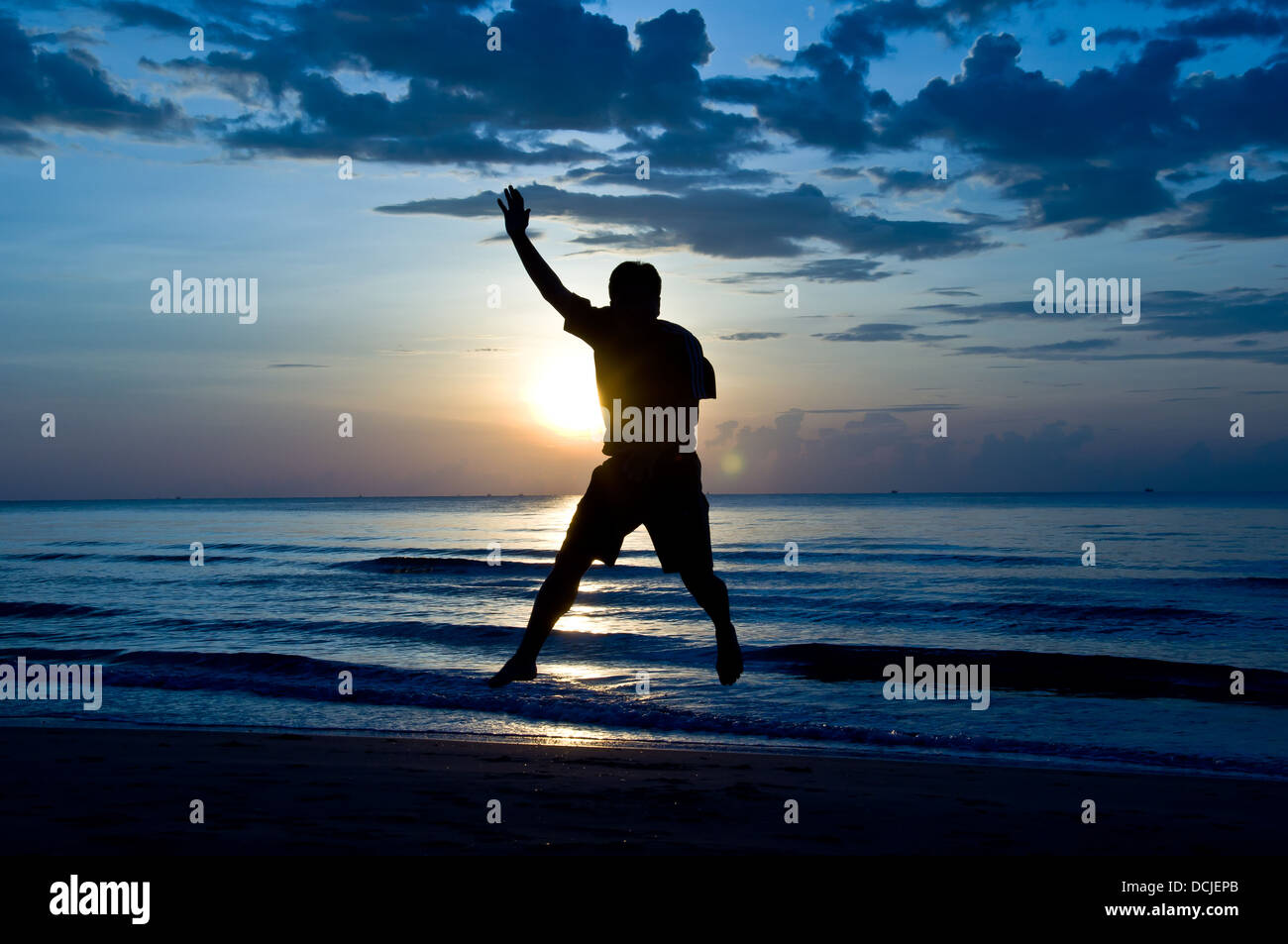 silhouette of man feel free and happy on the beach Stock Photo - Alamy
