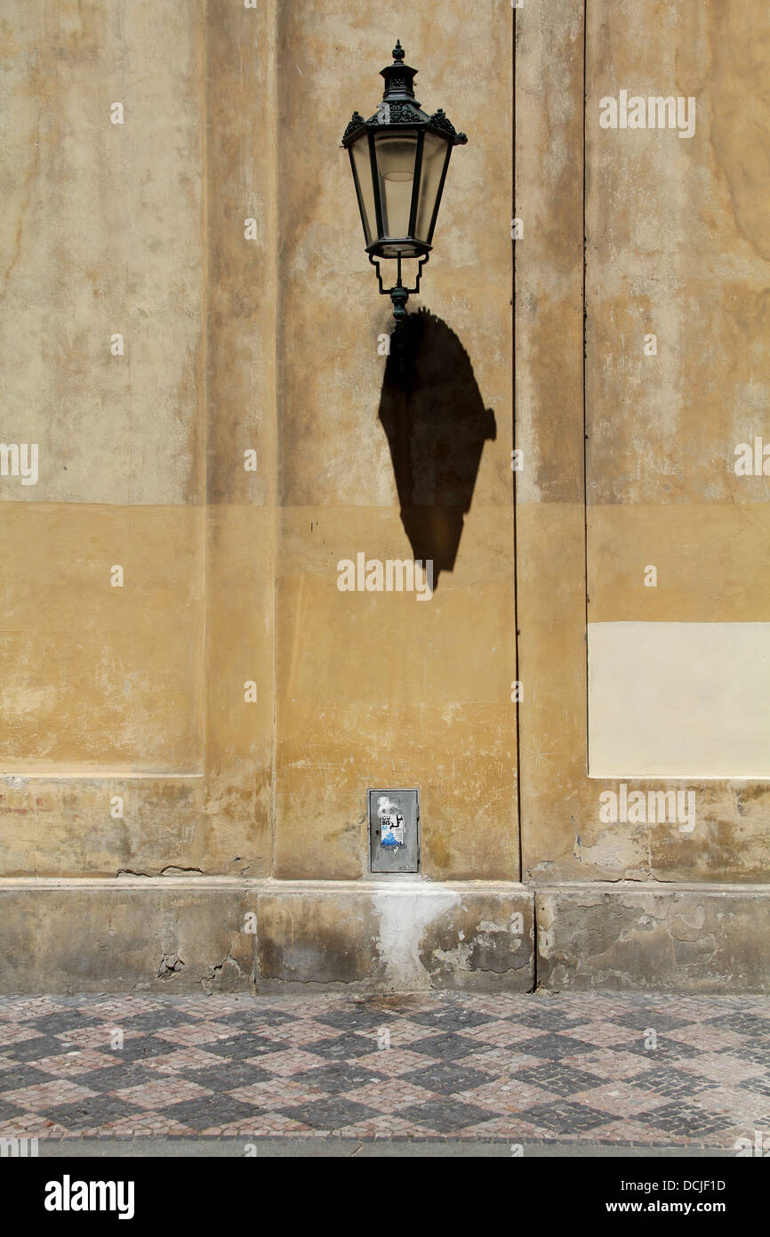 an eerie shadow reminiscent of a severed head is cast by a street lamp ...
