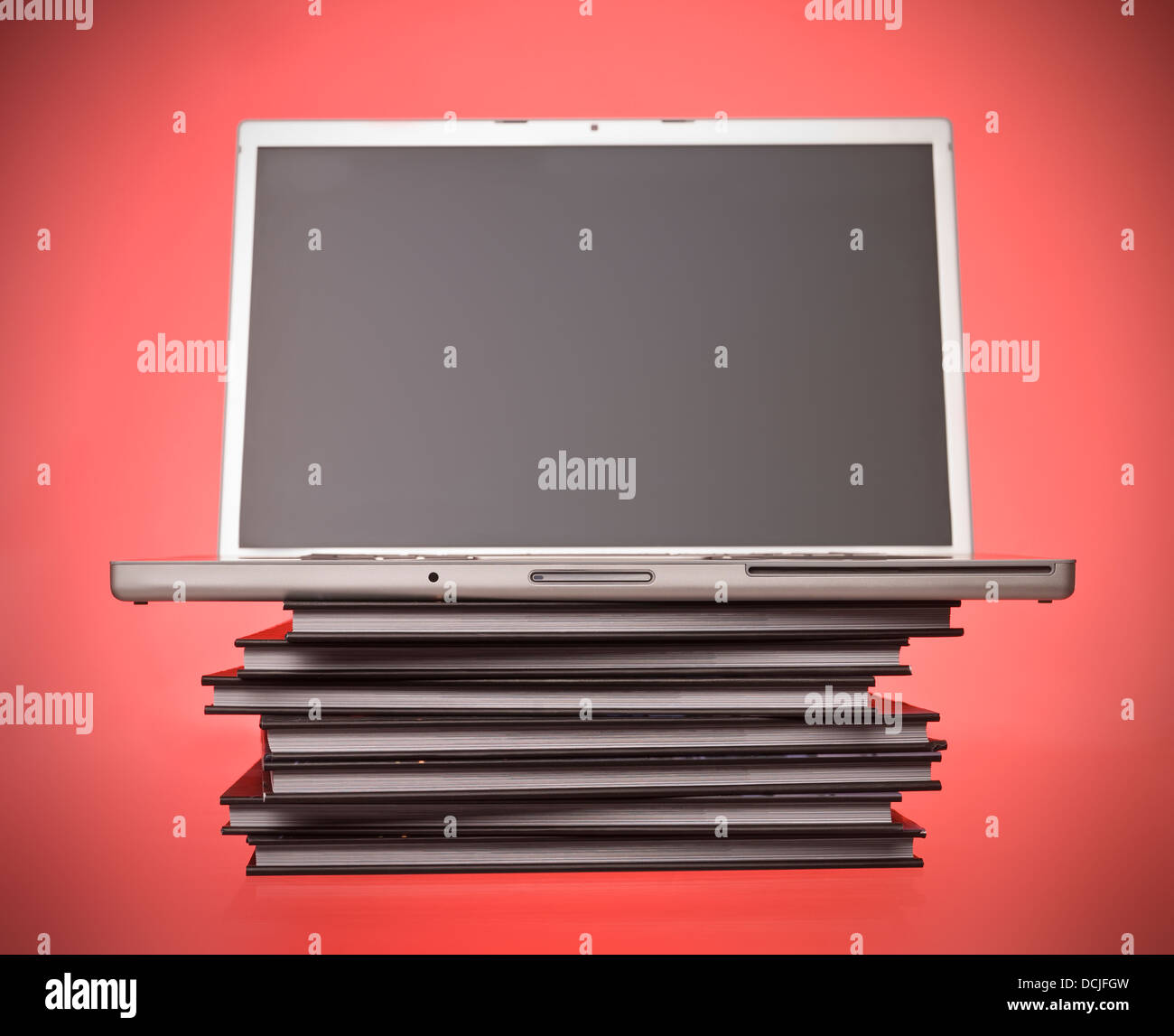Laptop on top of books Stock Photo - Alamy