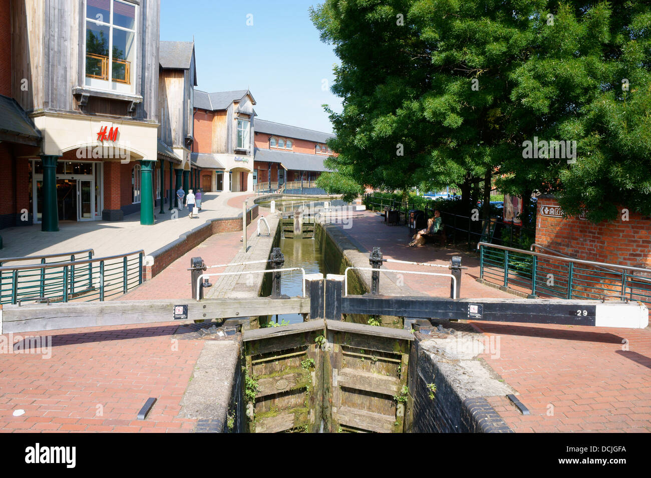 Locks on Oxford Canal with Castle Quay shopping centre in the ...