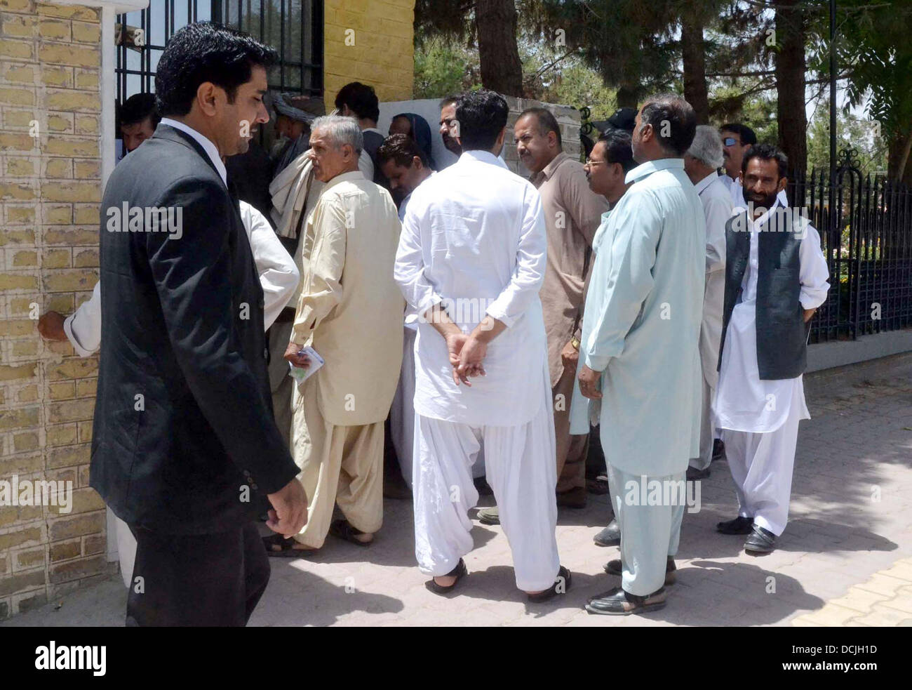 People stand in queue on the entrance of High Court premises during ...