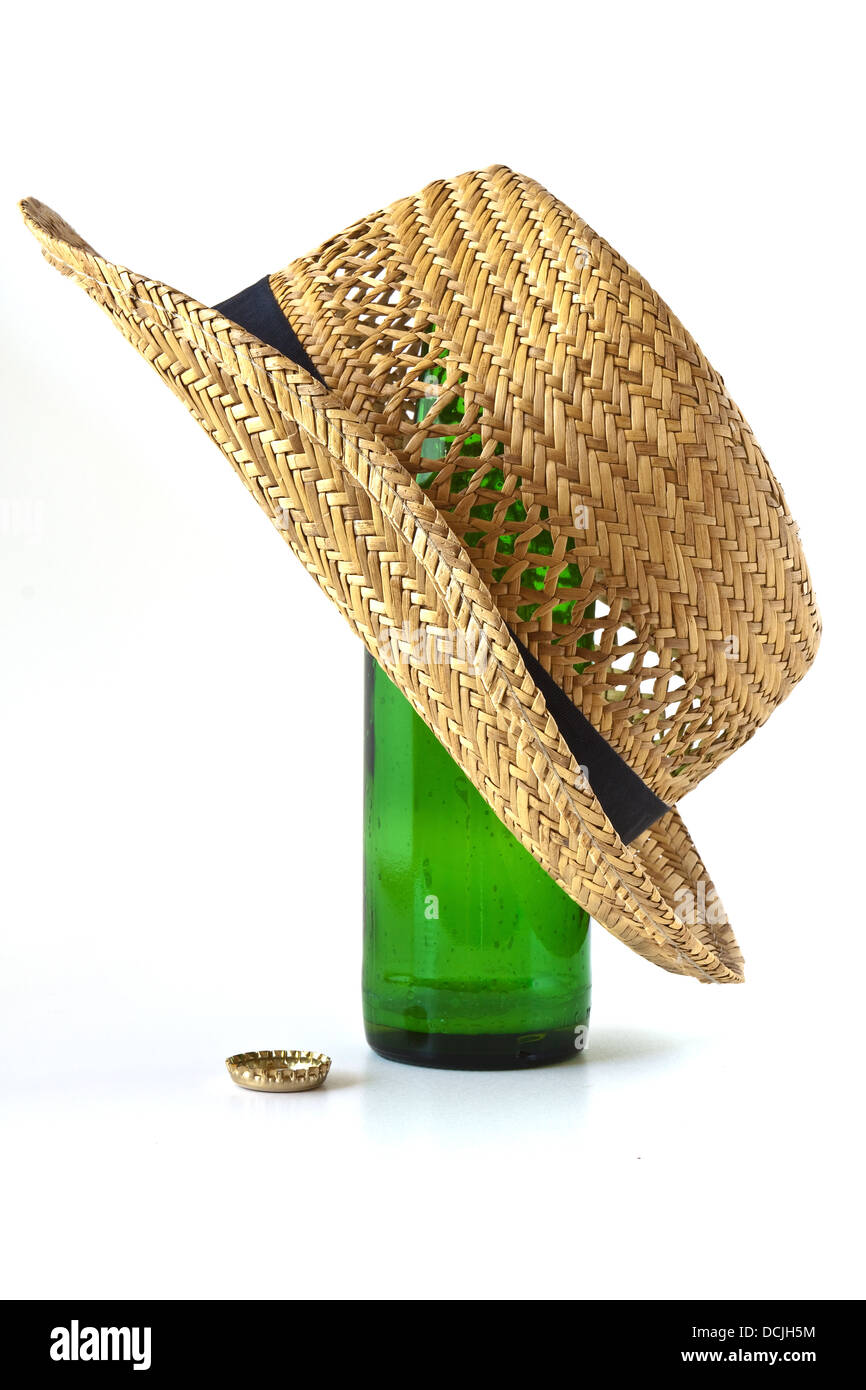 Green beer bottle and a summer straw hat Stock Photo - Alamy