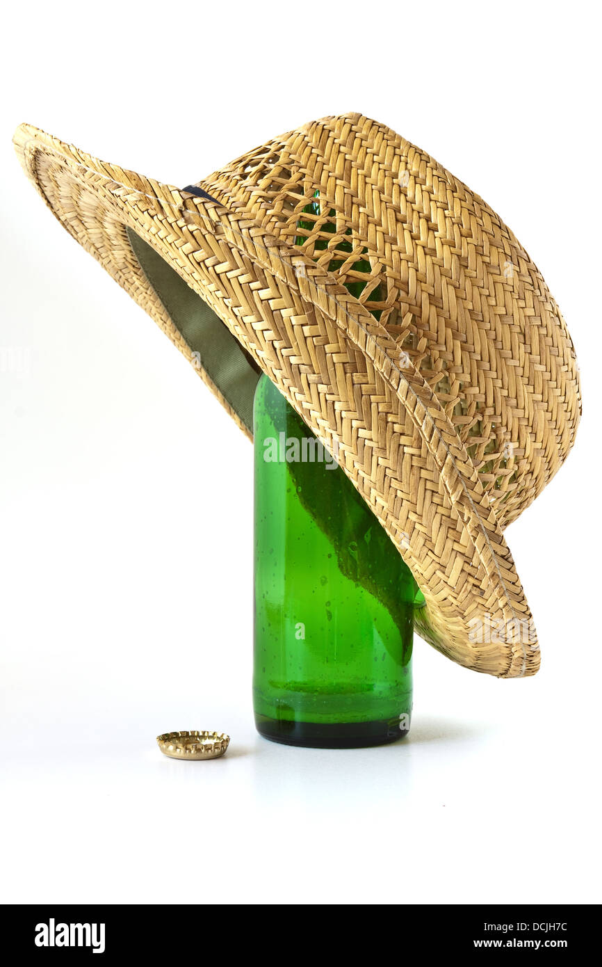 Green beer bottle and a summer straw hat Stock Photo - Alamy