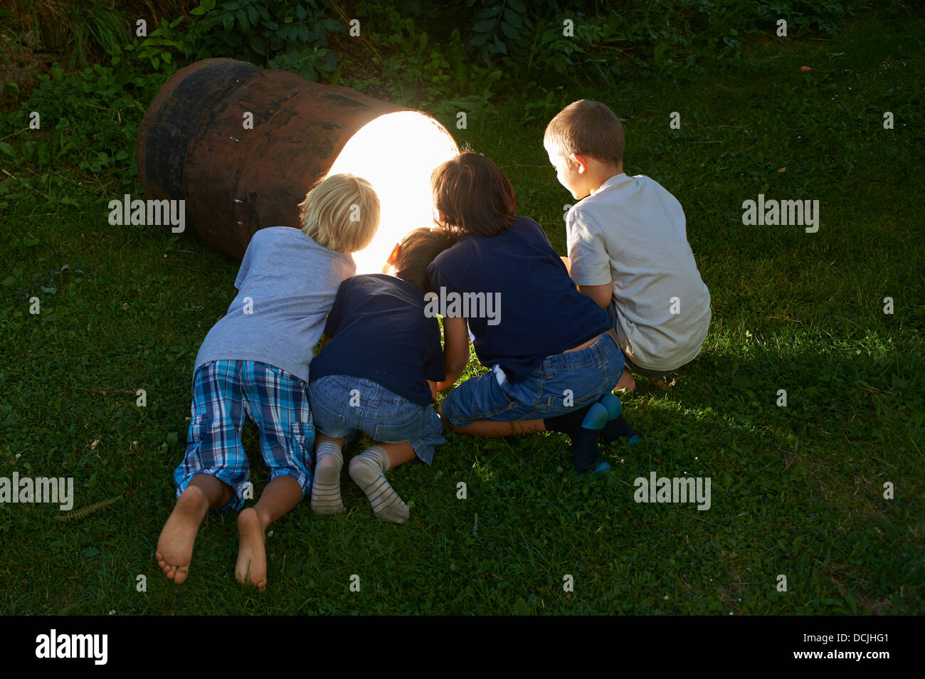 Child boy find a treasure in magic barrel at dusk Stock Photo - Alamy