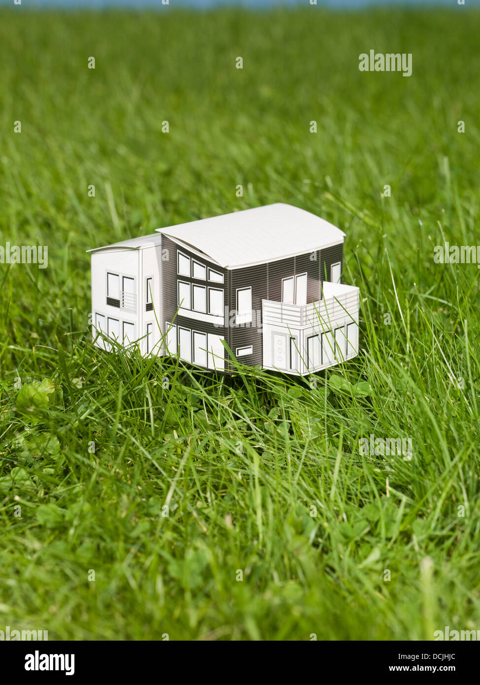 Model house on green grass Stock Photo - Alamy
