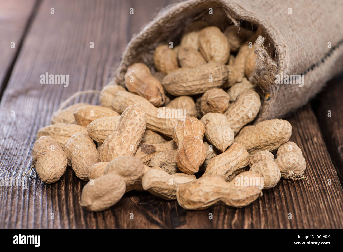 Peanuts in a small Sack on wooden background Stock Photo - Alamy