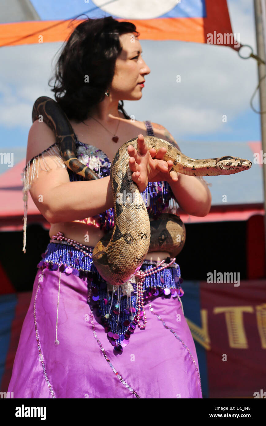 A snake charmer woman at a carnival act at the Steele County Fair in ...