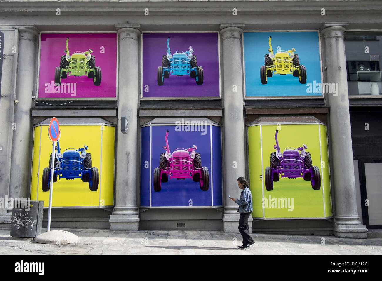 tractors displayed as pop art, man walking by Stock Photo - Alamy