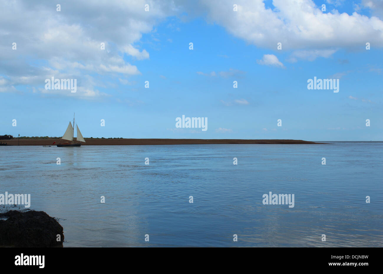Sailboat leaving the estuary Stock Photo - Alamy