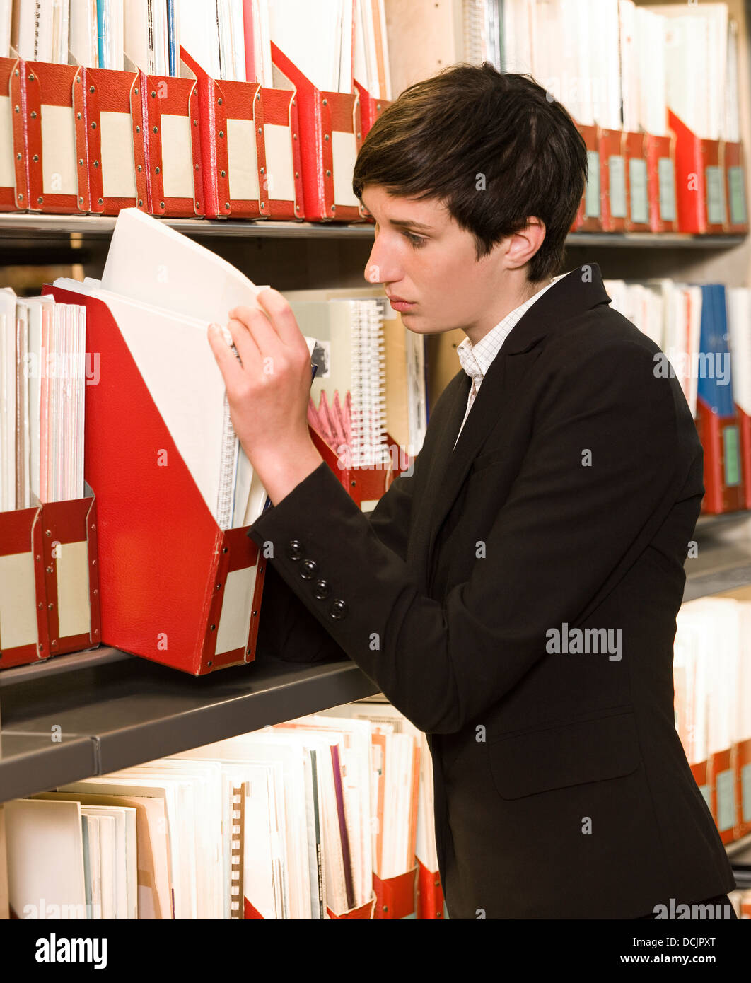 Woman searching at an archive Stock Photo - Alamy