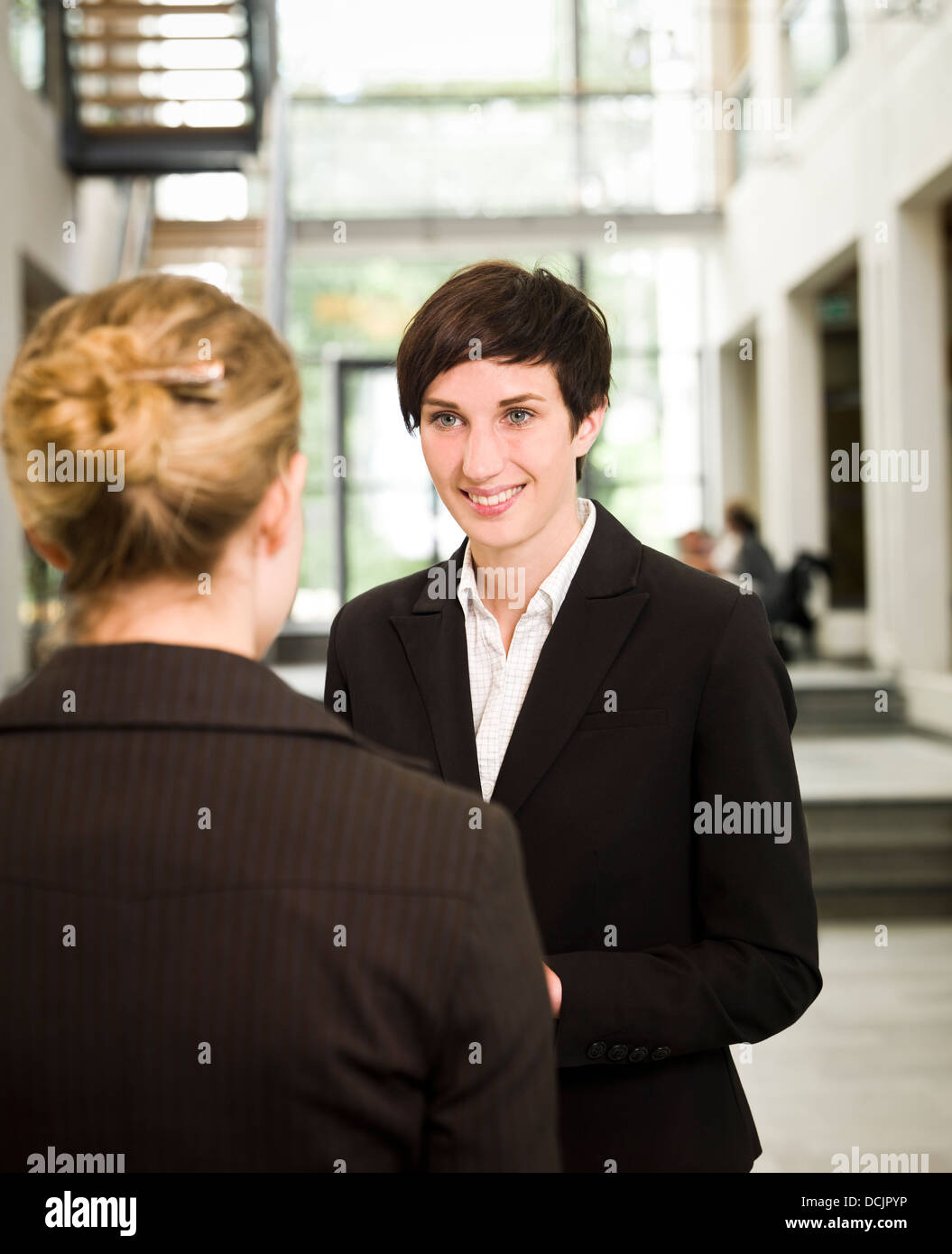 Two women in a conversation Stock Photo - Alamy