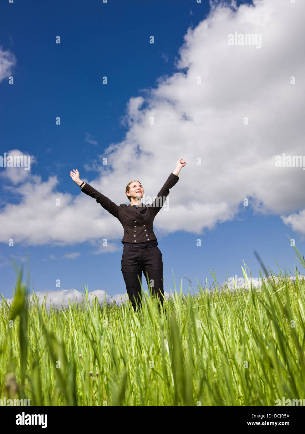 Young woman with her arms raised Stock Photo - Alamy