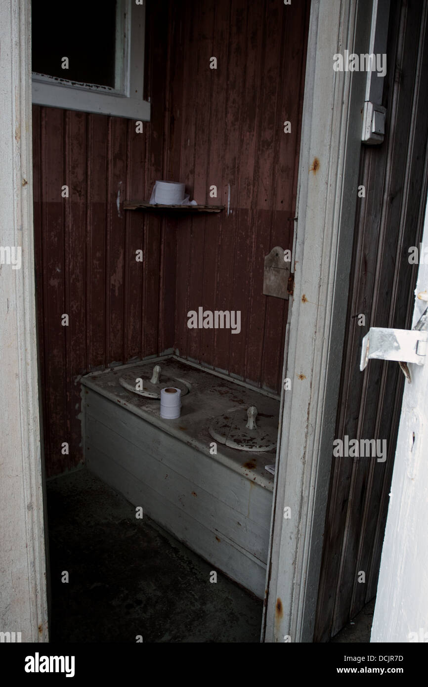 Old fashioned lavatories in Norwegian outhouse Stock Photo - Alamy
