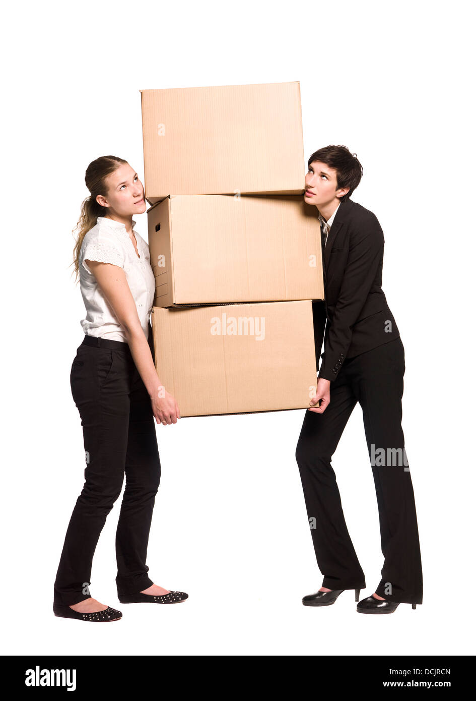 Two women carrying three boxes Stock Photo - Alamy