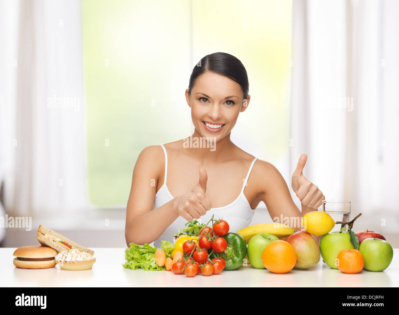 woman with fruits rejecting junk food Stock Photo - Alamy