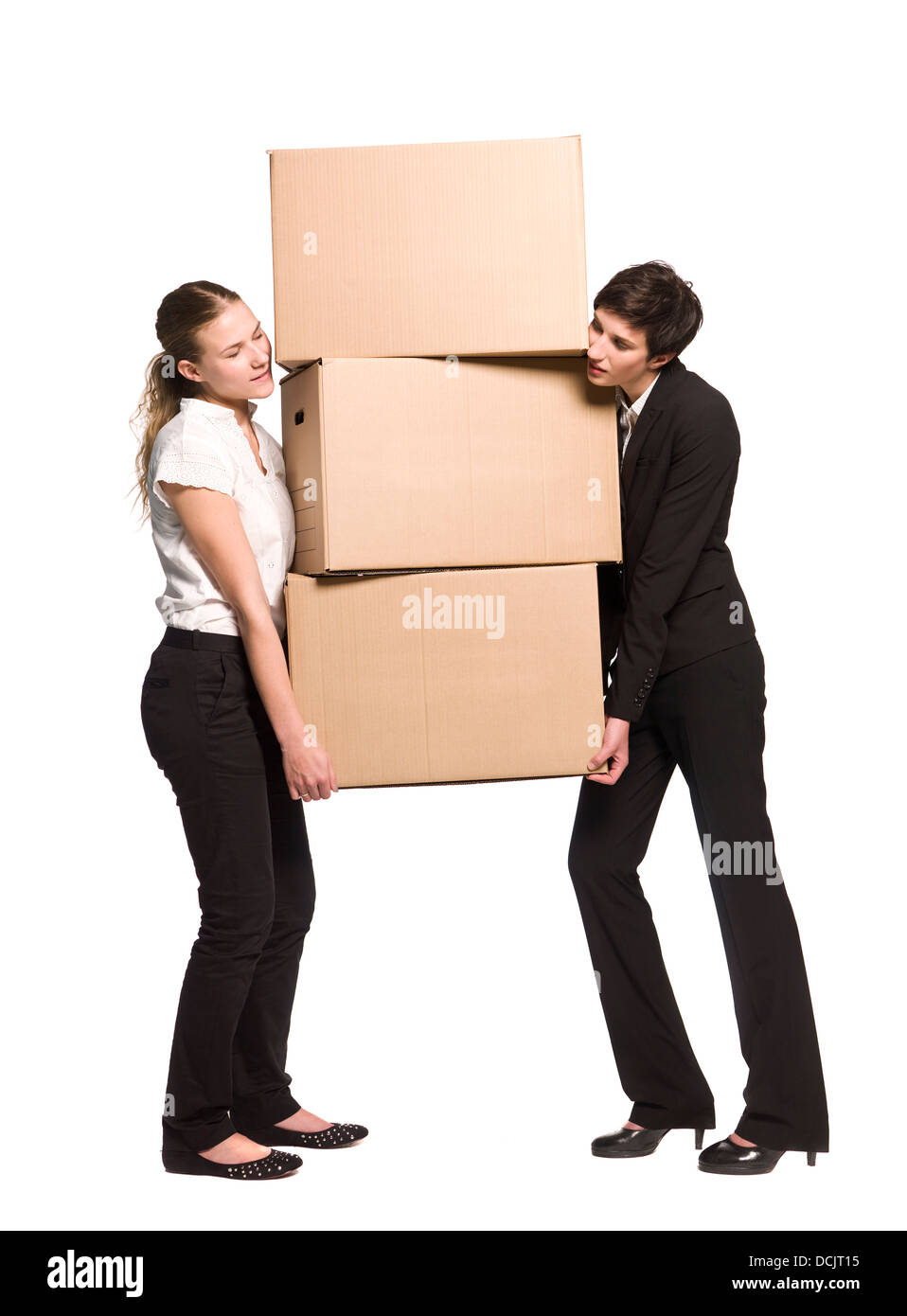 Two women carrying three boxes Stock Photo - Alamy