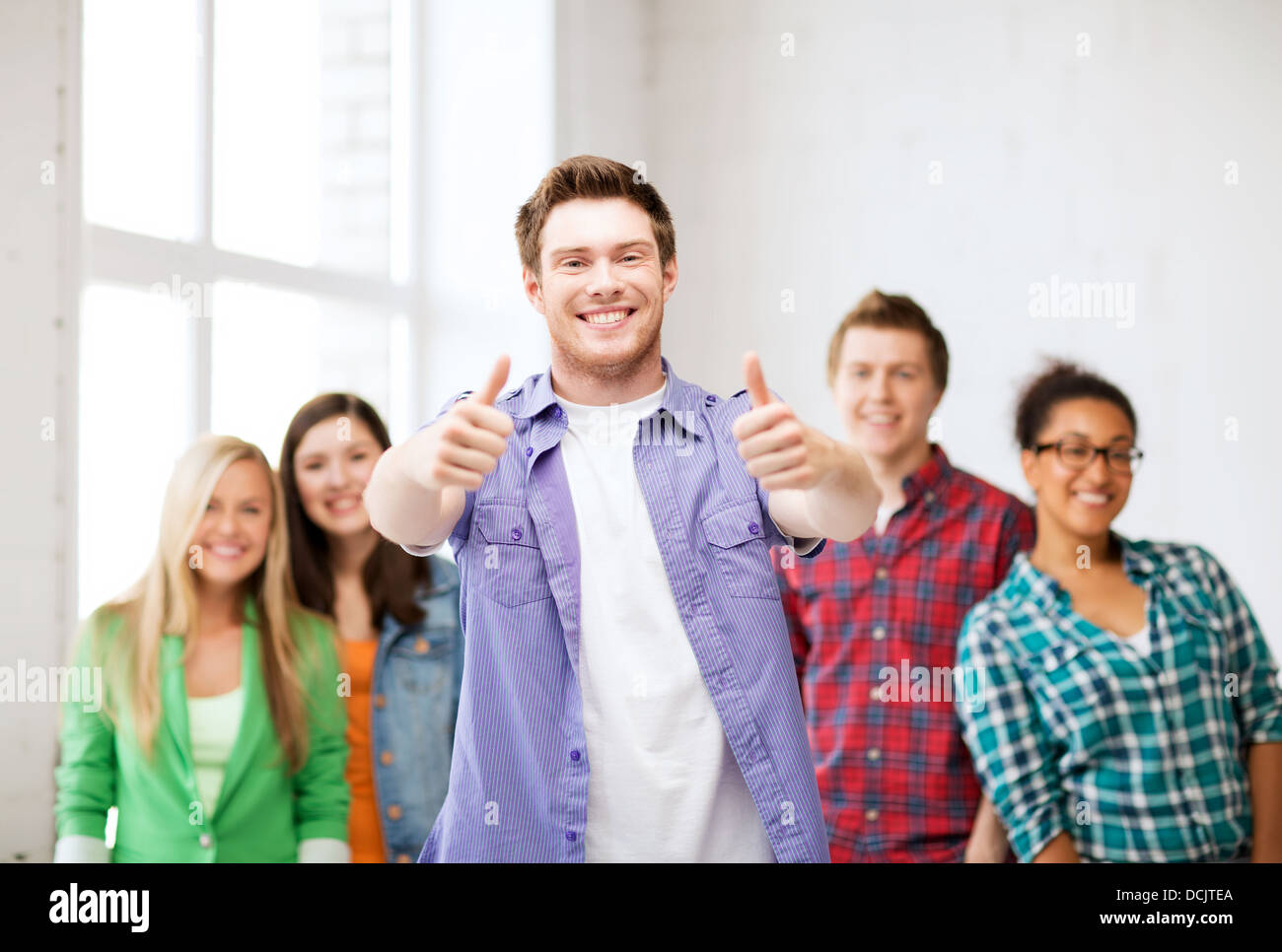 student with group of students at school Stock Photo - Alamy