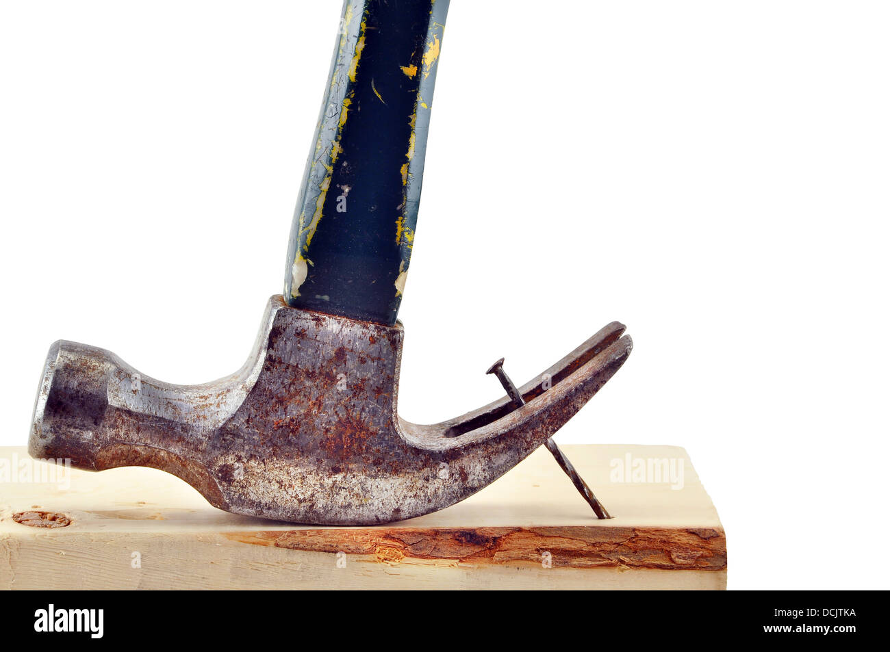 Rusted hammer pulling out a nail Stock Photo - Alamy