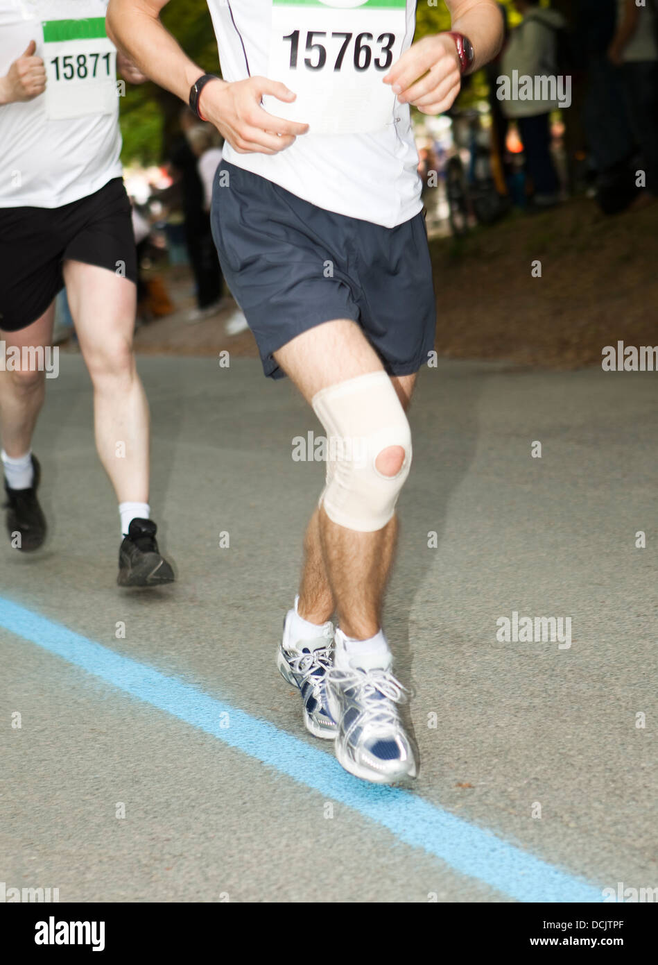 Injured runner in a competition Stock Photo - Alamy