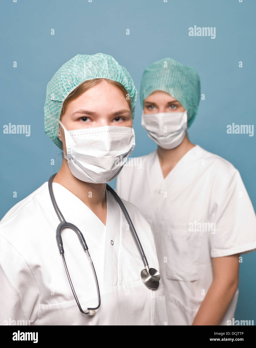Two nurses with surgical masks and a stethoscope Stock Photo - Alamy