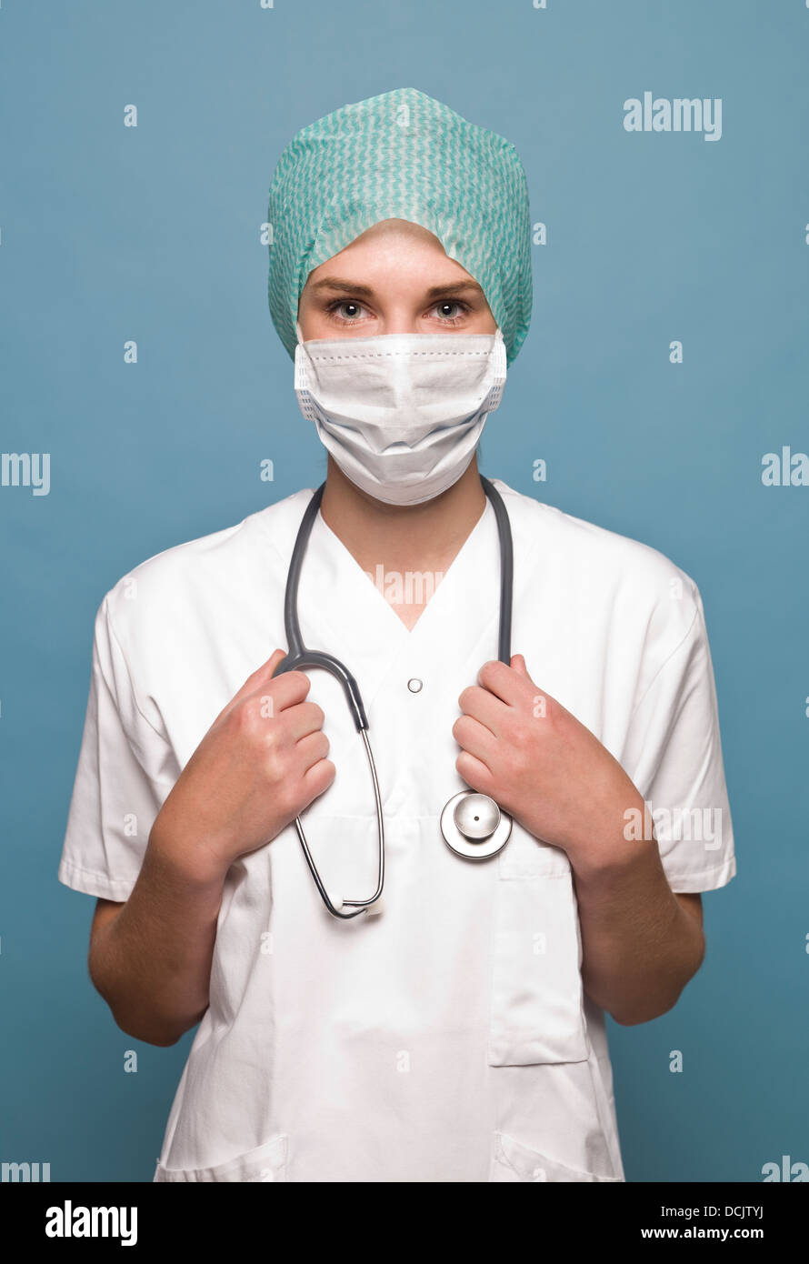 Female nurse with surgical mask and a stethoscope Stock Photo - Alamy