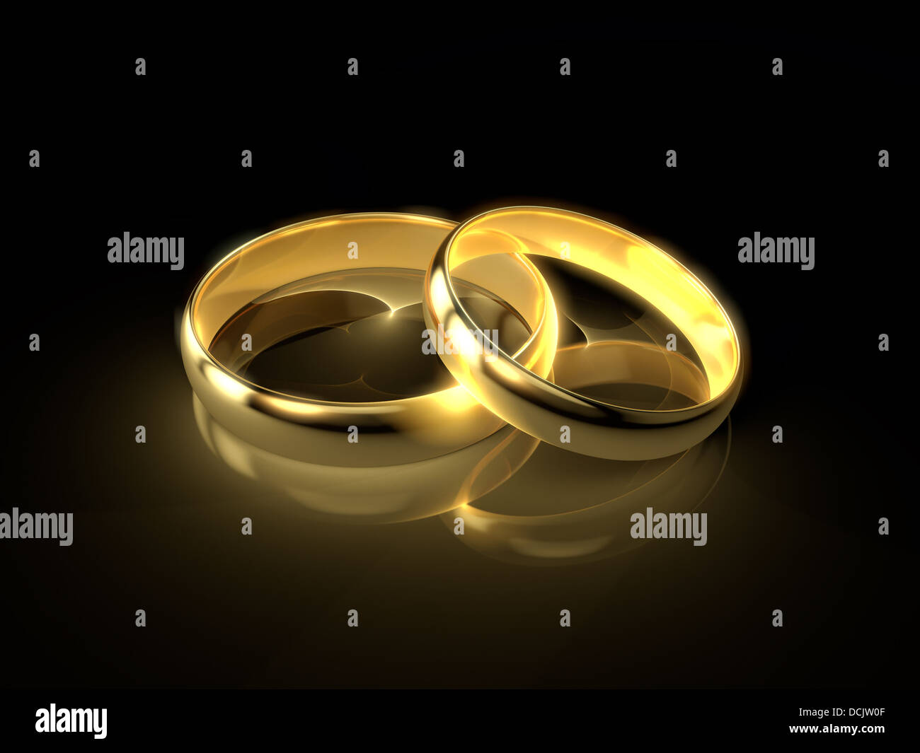 Two golden wedding rings isolated on black background Stock Photo - Alamy