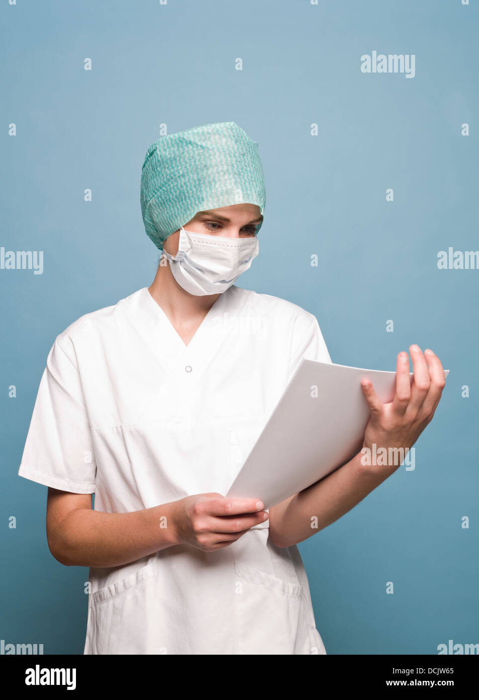 Nurse with surgical mask and a journal Stock Photo - Alamy