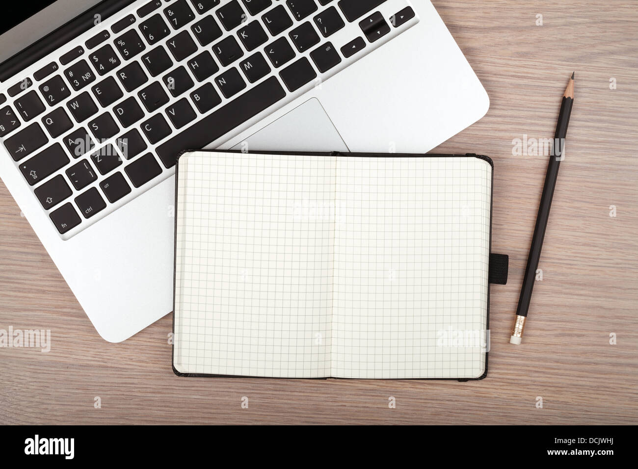 Notepad and laptop on wood table. View from above Stock Photo - Alamy