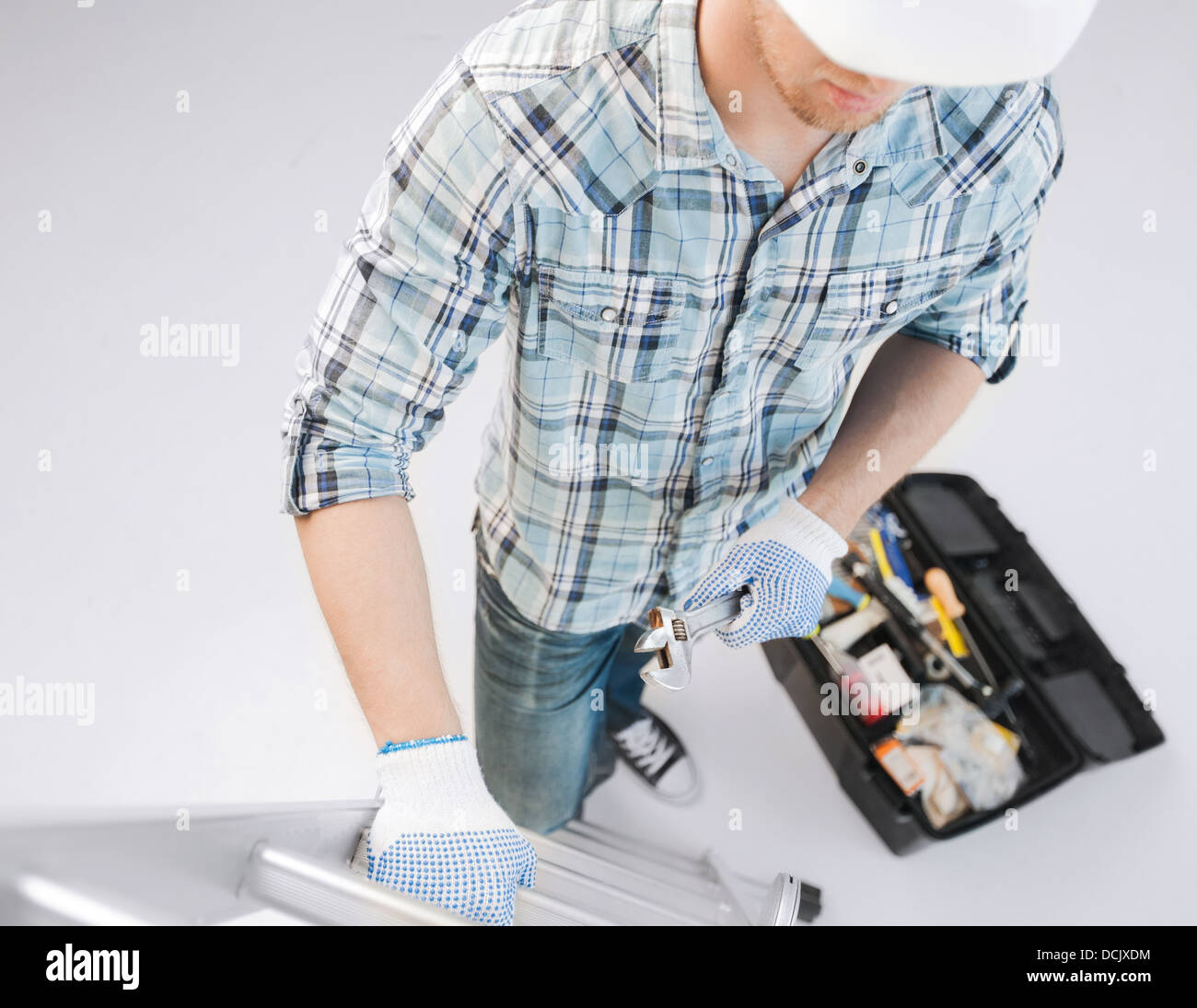man with ladder, toolkit and spanner Stock Photo - Alamy