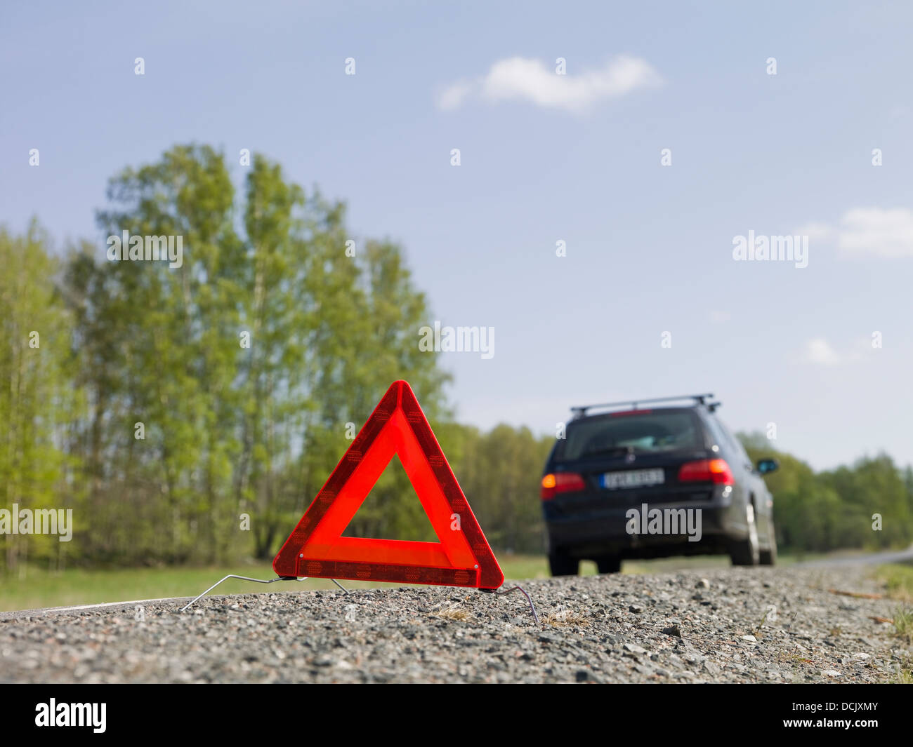 Warning triangle in front of a car breakdown Stock Photo - Alamy