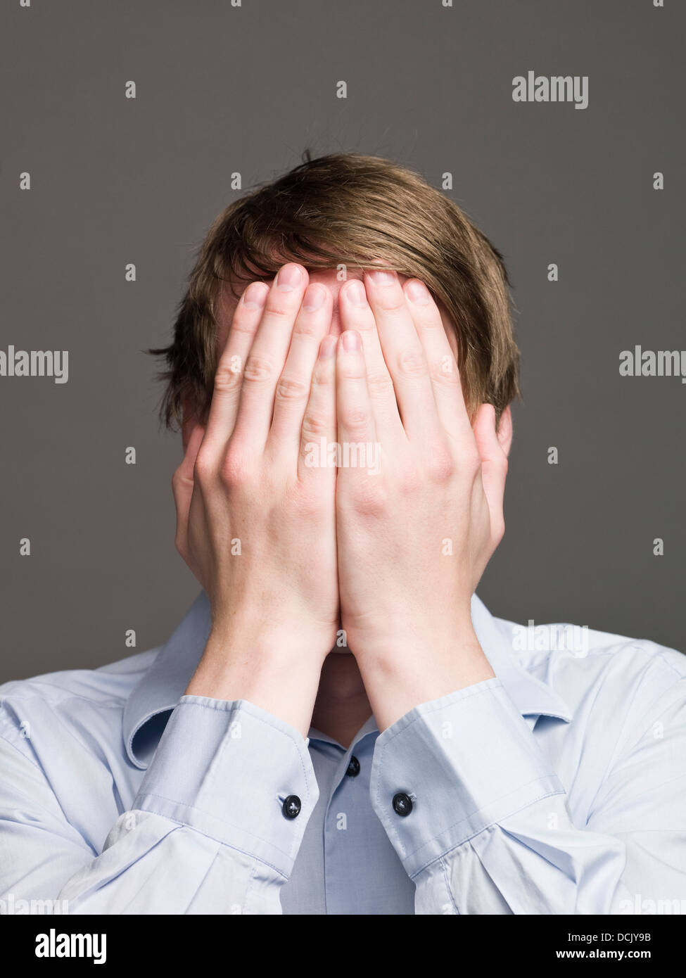 Man with his hands in over his face Stock Photo - Alamy