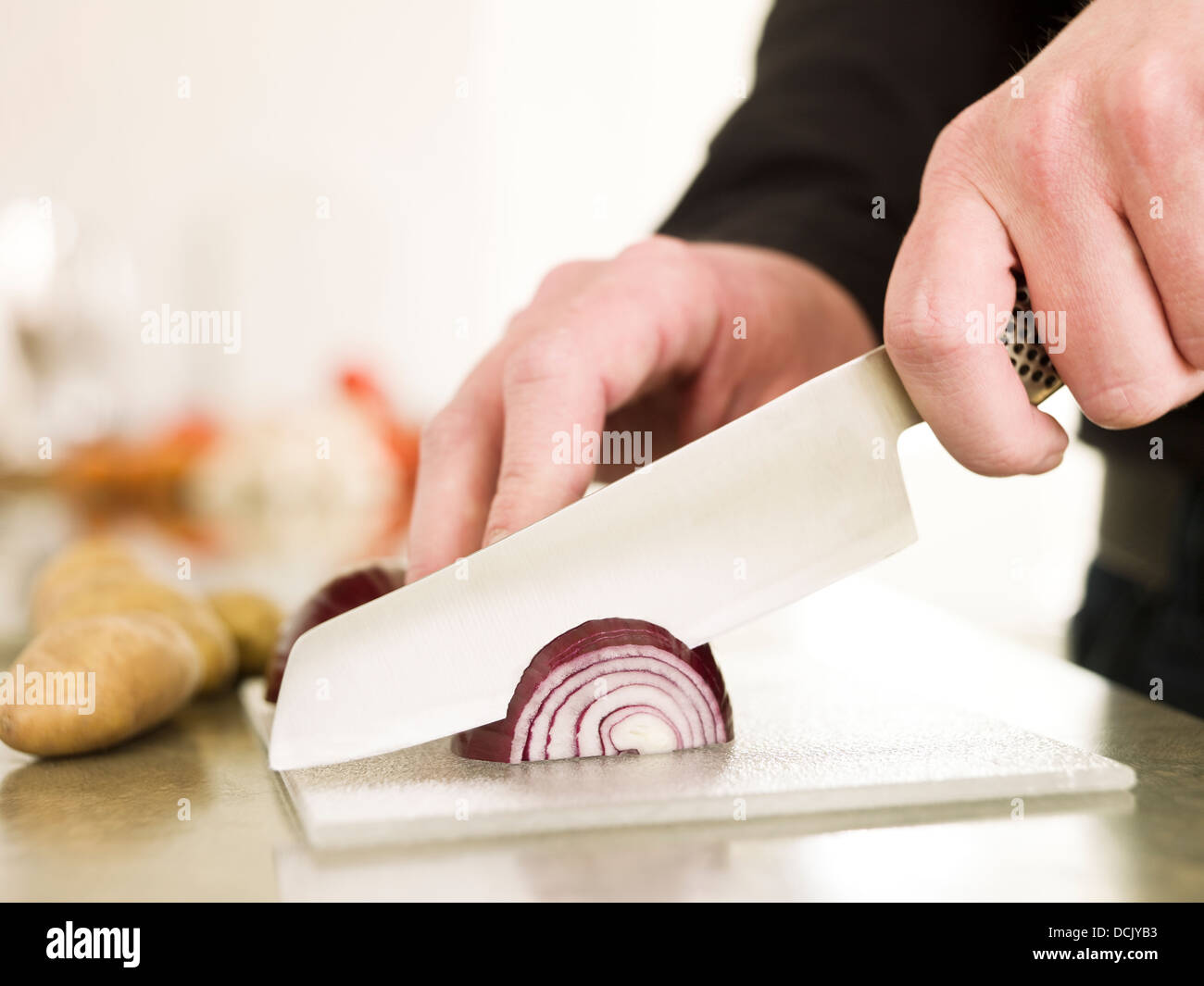 Cutting onion with a knife Stock Photo - Alamy