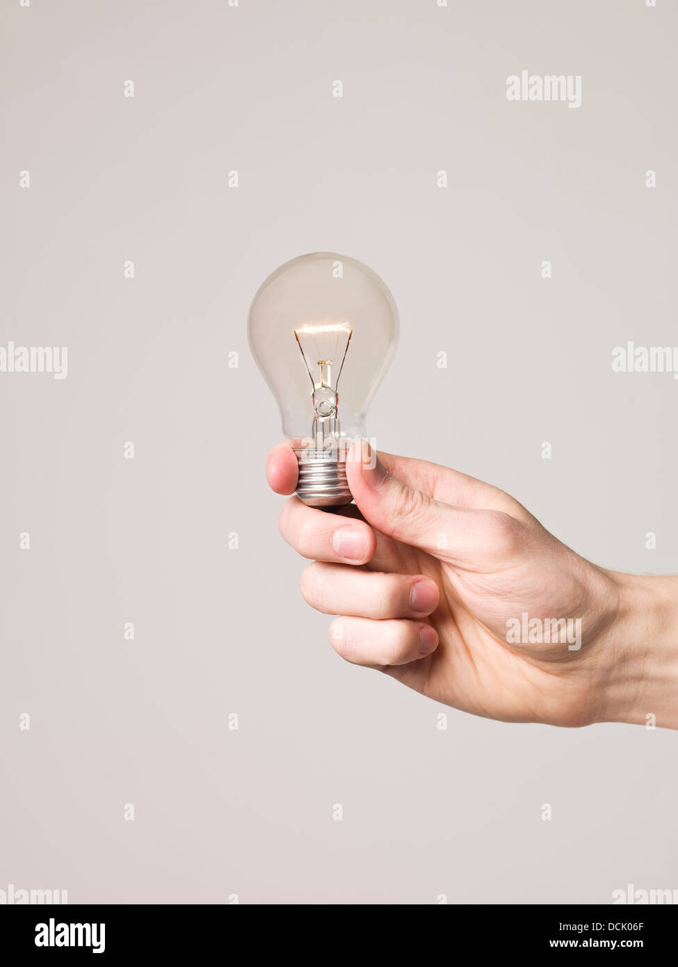 Hand holding shining light-bulb Stock Photo - Alamy