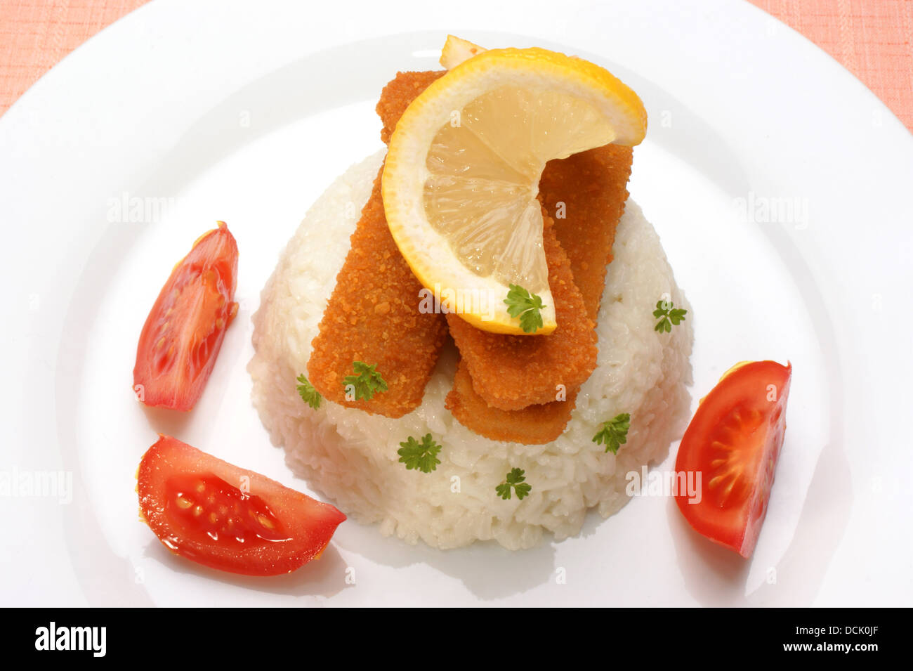 Fish fingers with rice on a plate Stock Photo - Alamy