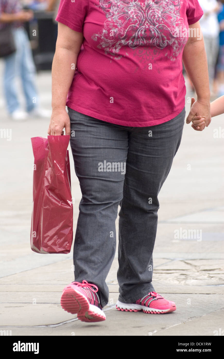 UK Obesity. Overweight fat obese mother holding daughters hand London ...