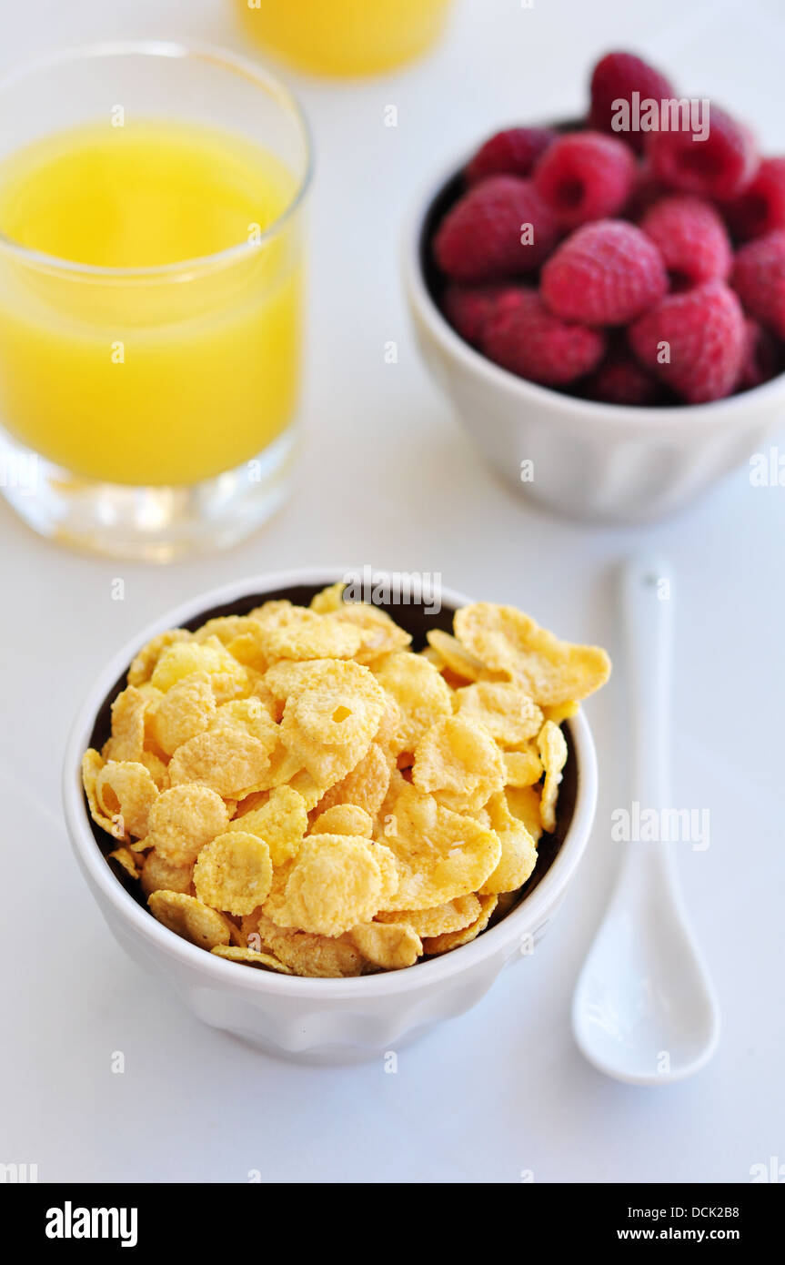 corn flakes and fresh raspberry in ceramic bowl closeup Stock Photo - Alamy
