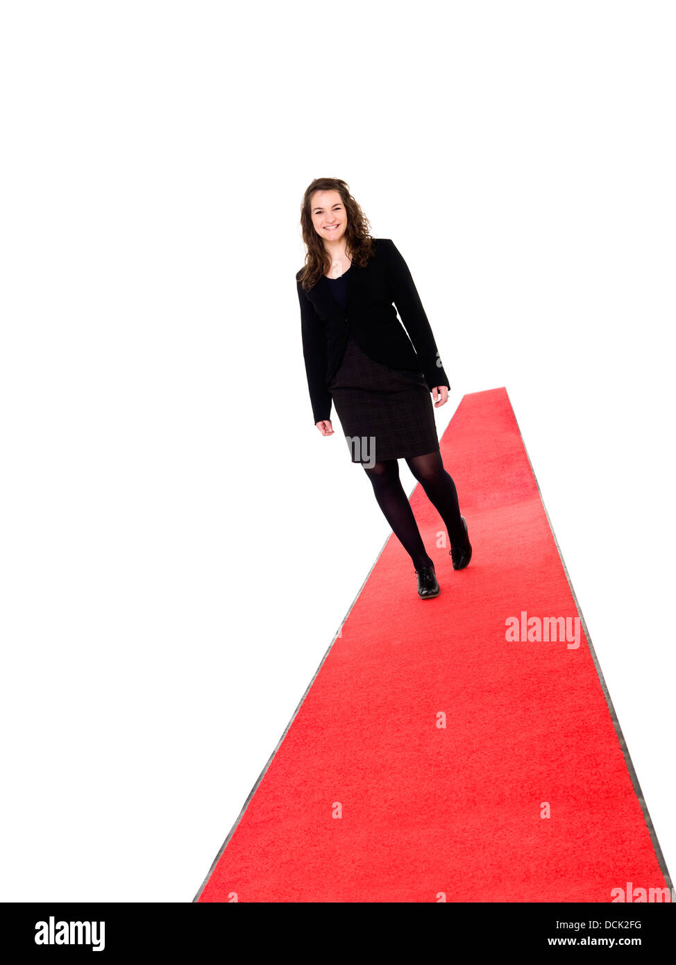 Smiling girl walking on red carpet Stock Photo - Alamy